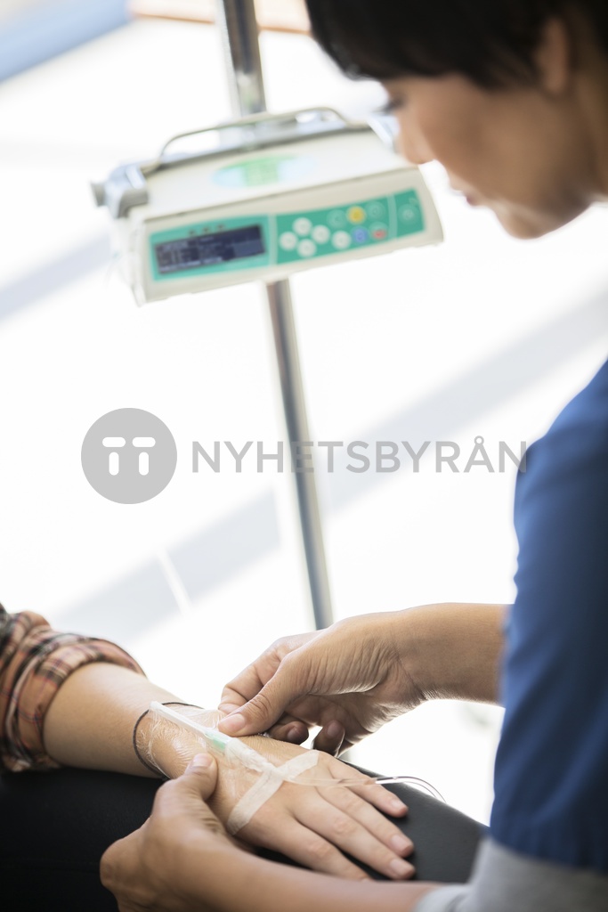 Doctor administering intravenous infusion to patient