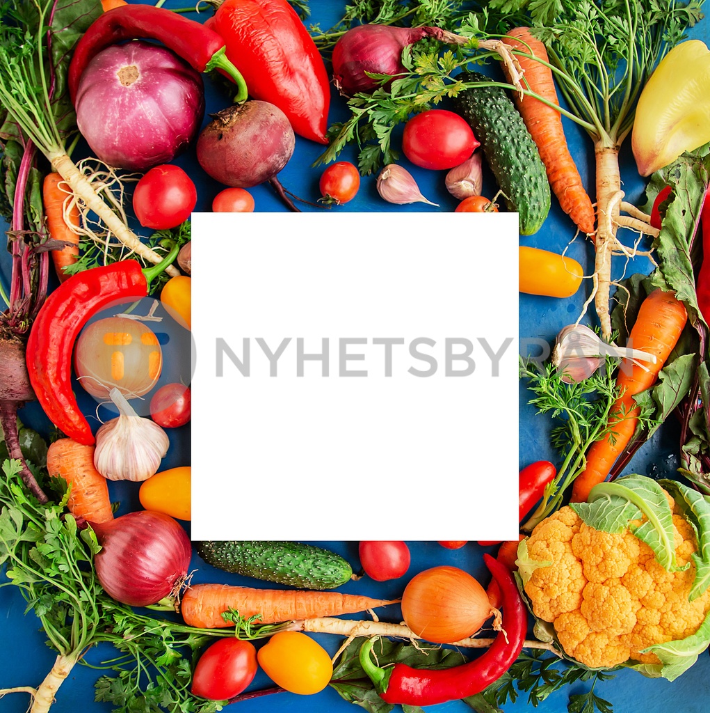 Composition with raw vegetables on a blue background. Frame of vegetables.