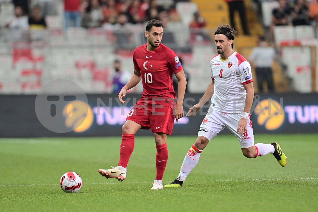 Hakan Calhanoglu (L) of Turkey and Drasko Bozovic (8) of Montenegro ...