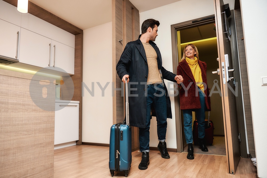 A good place to be. Couple entering their room in a hotel