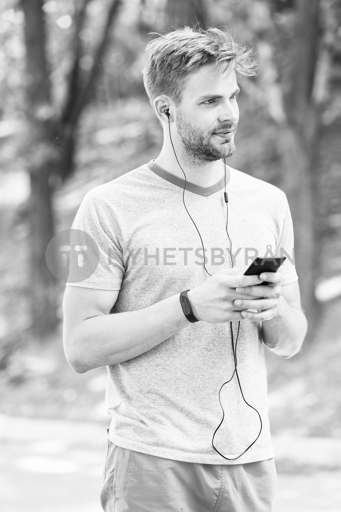 Living a mobile lifestyle. Athletic man tracking his activity with ...