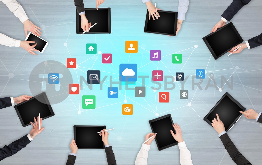 Group of people with devices in hands working on laptops and tab