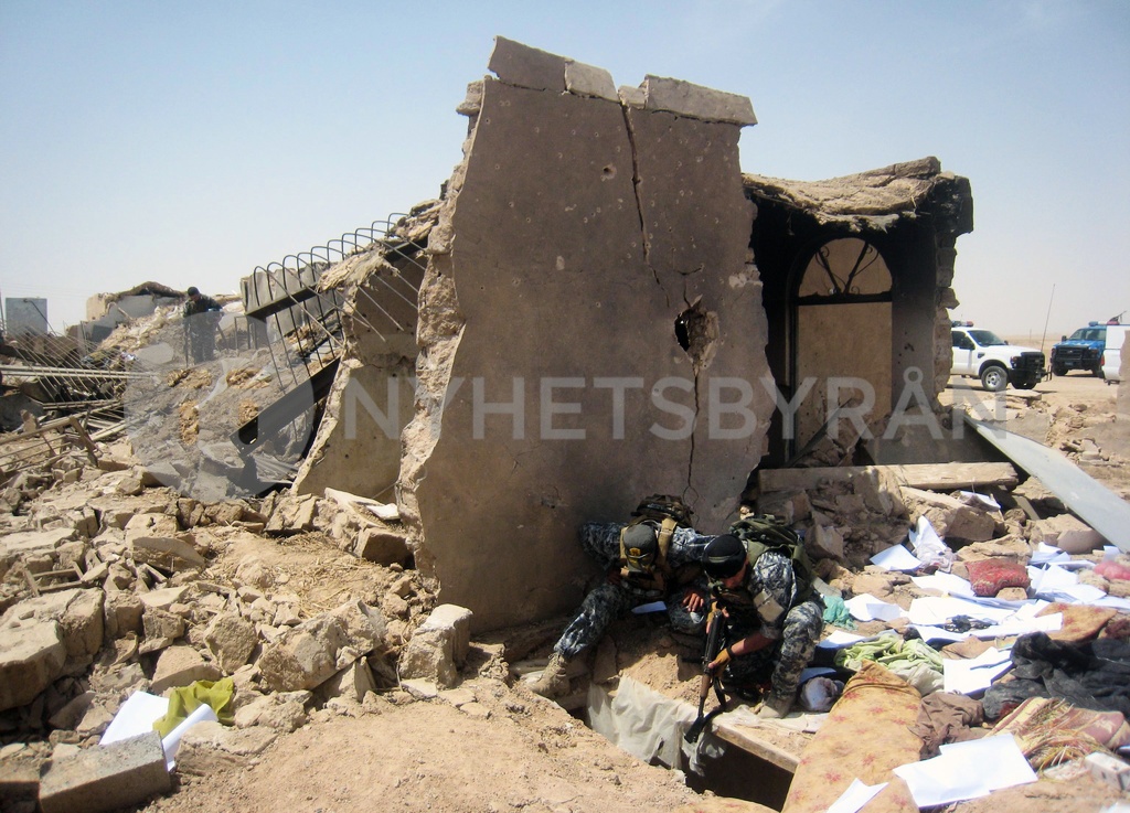 iraqi policemen are seen at the site of a joint u s iraqi raid that ...