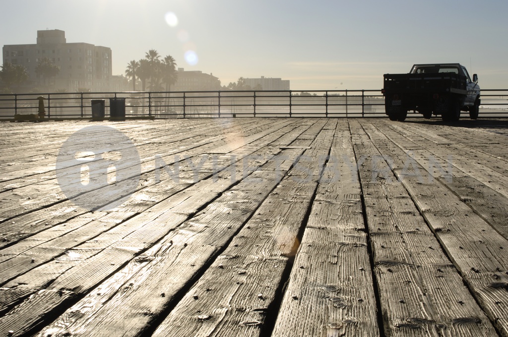 Pier seen from floor level with wooden planks making strong perspective ...