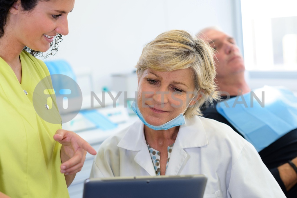 female dentist her assistant and patient in dental practice
