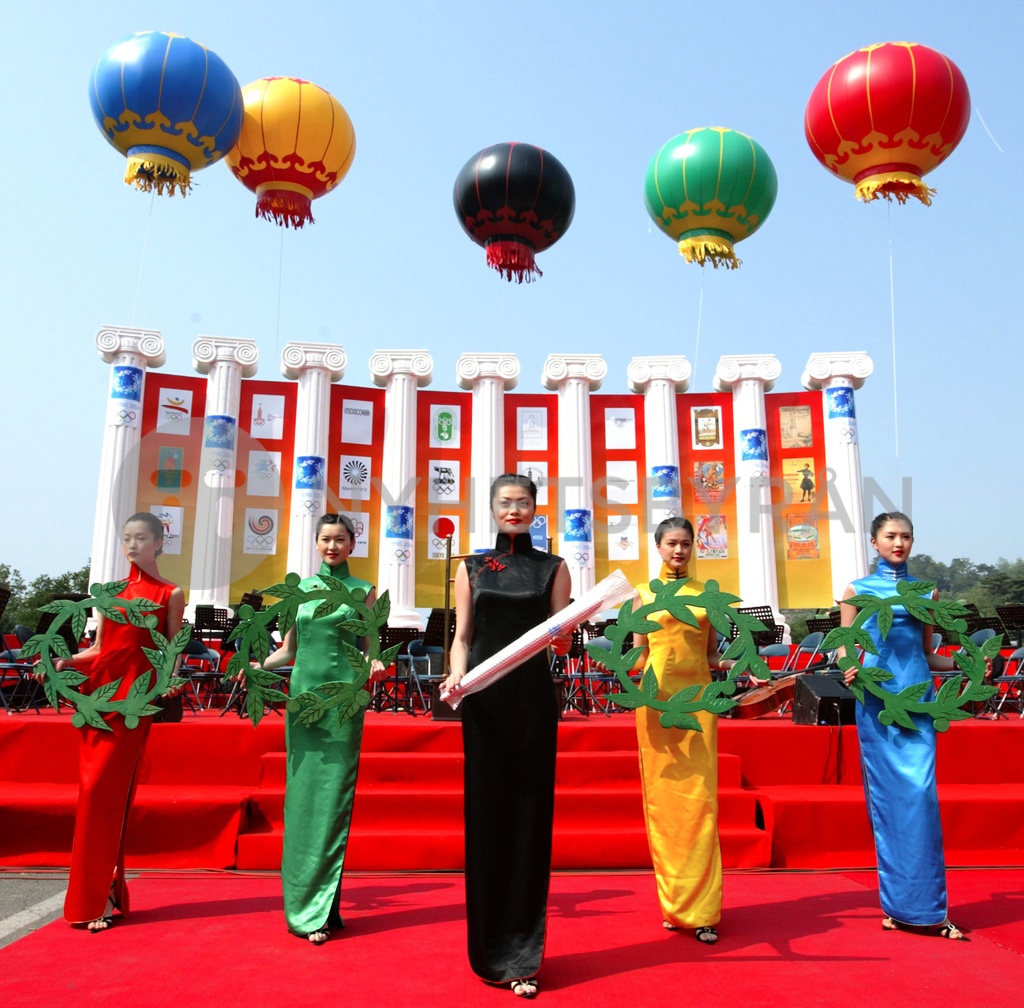 A CHINESE MODEL HOLDS THE OLYMPIC TORCH DURING A CELEBRATION IN BEIJING