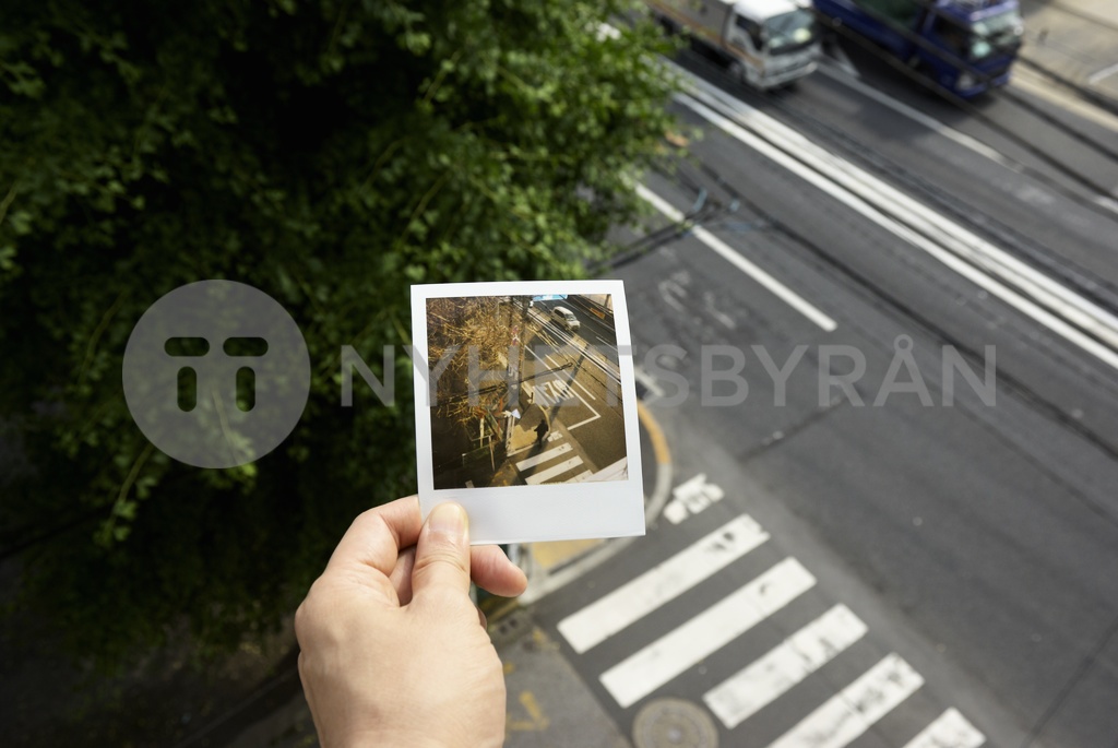 Juxtaposed Polaroid picture with same photographed street scenery ...
