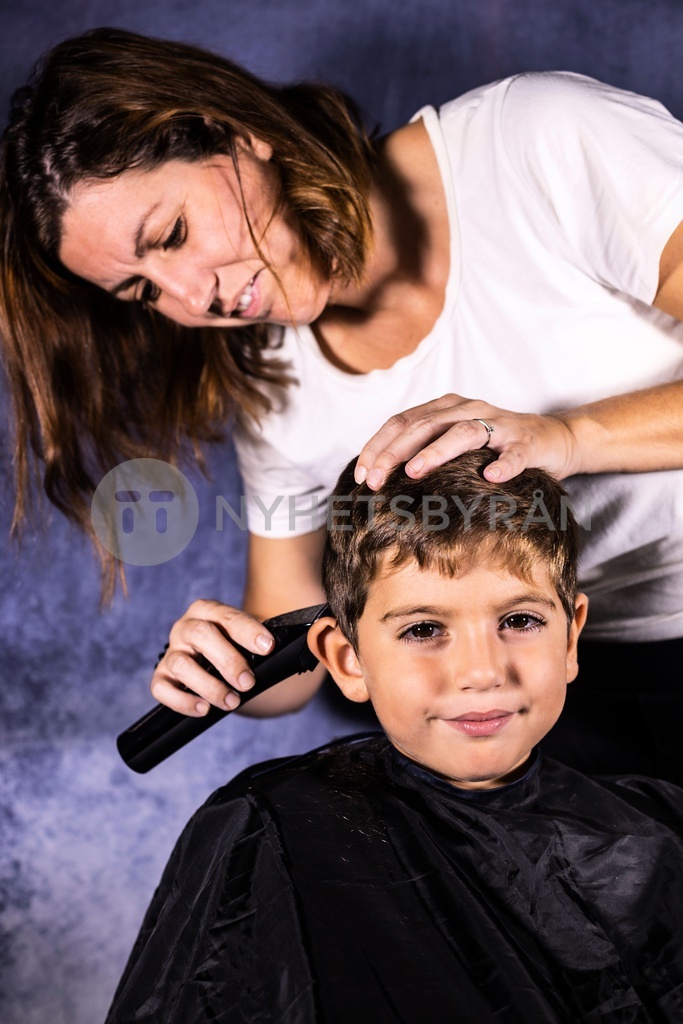 Little boy getting a haircut with a cutting machine